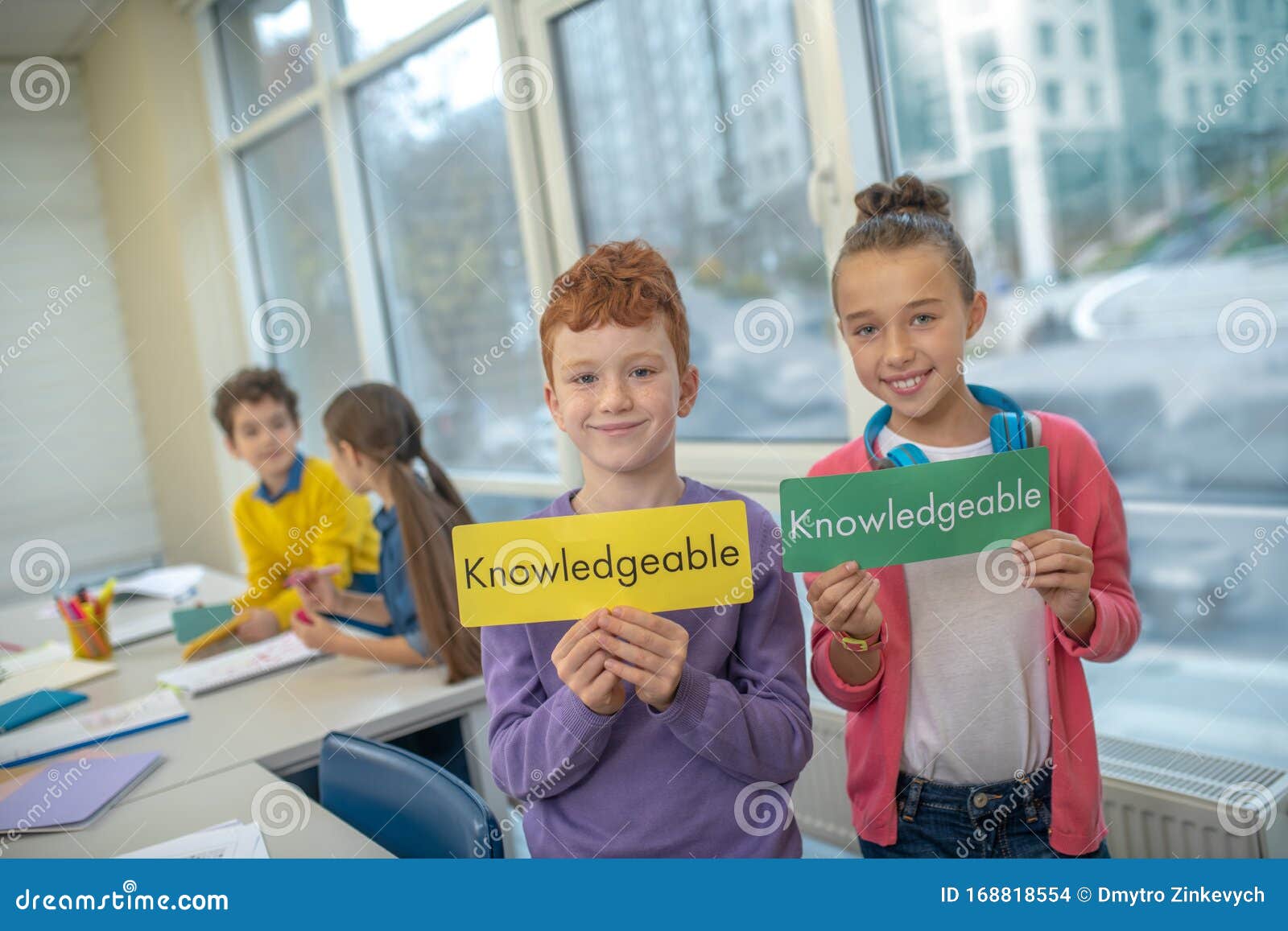 Two Smiling Kids Holding the Word Knowledgeable Stock Photo - Image of ...