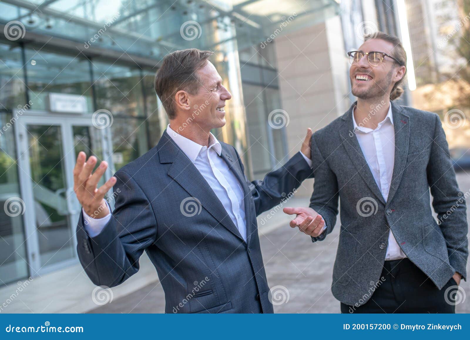 Two Smiling Male Colleagues Having Friendly Conversation Outside Stock ...