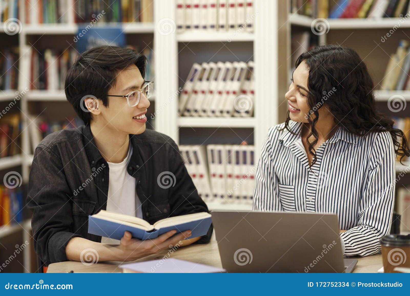 Two Smiling Multicultural Students Learning at Library Stock Photo ...