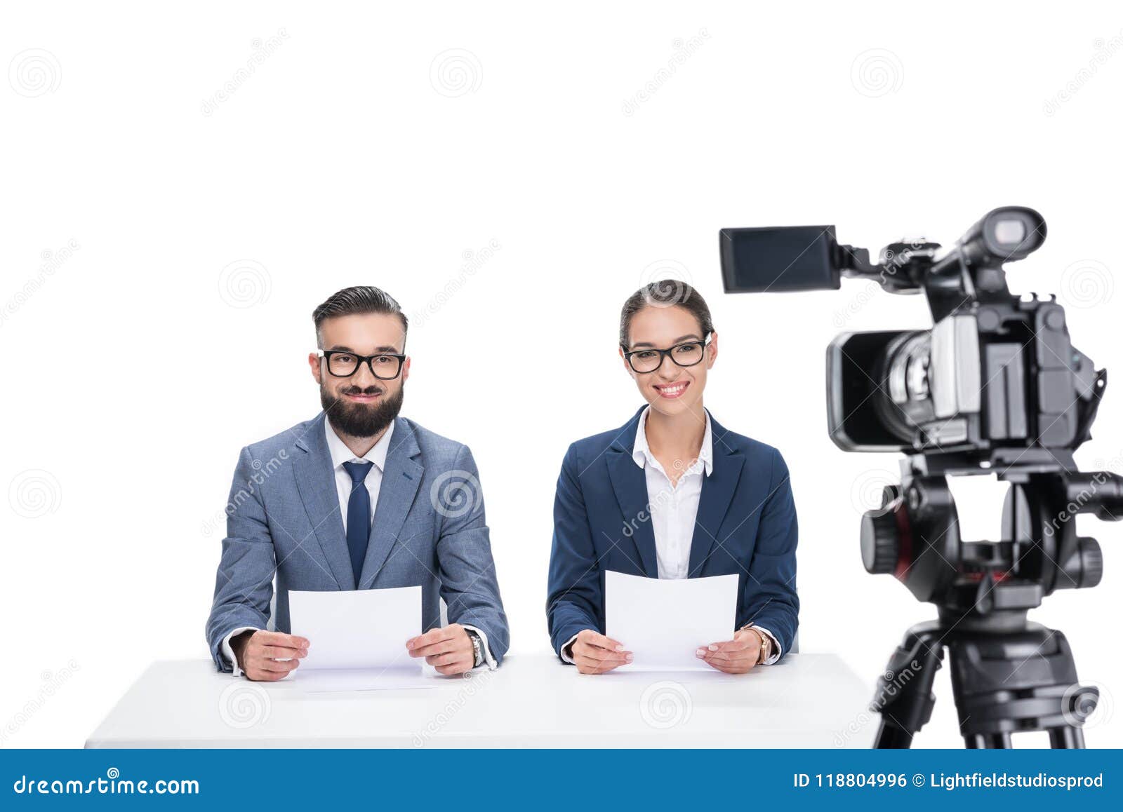 Two Smiling Newscasters with Papers Sitting in Front of Camera, Stock ...