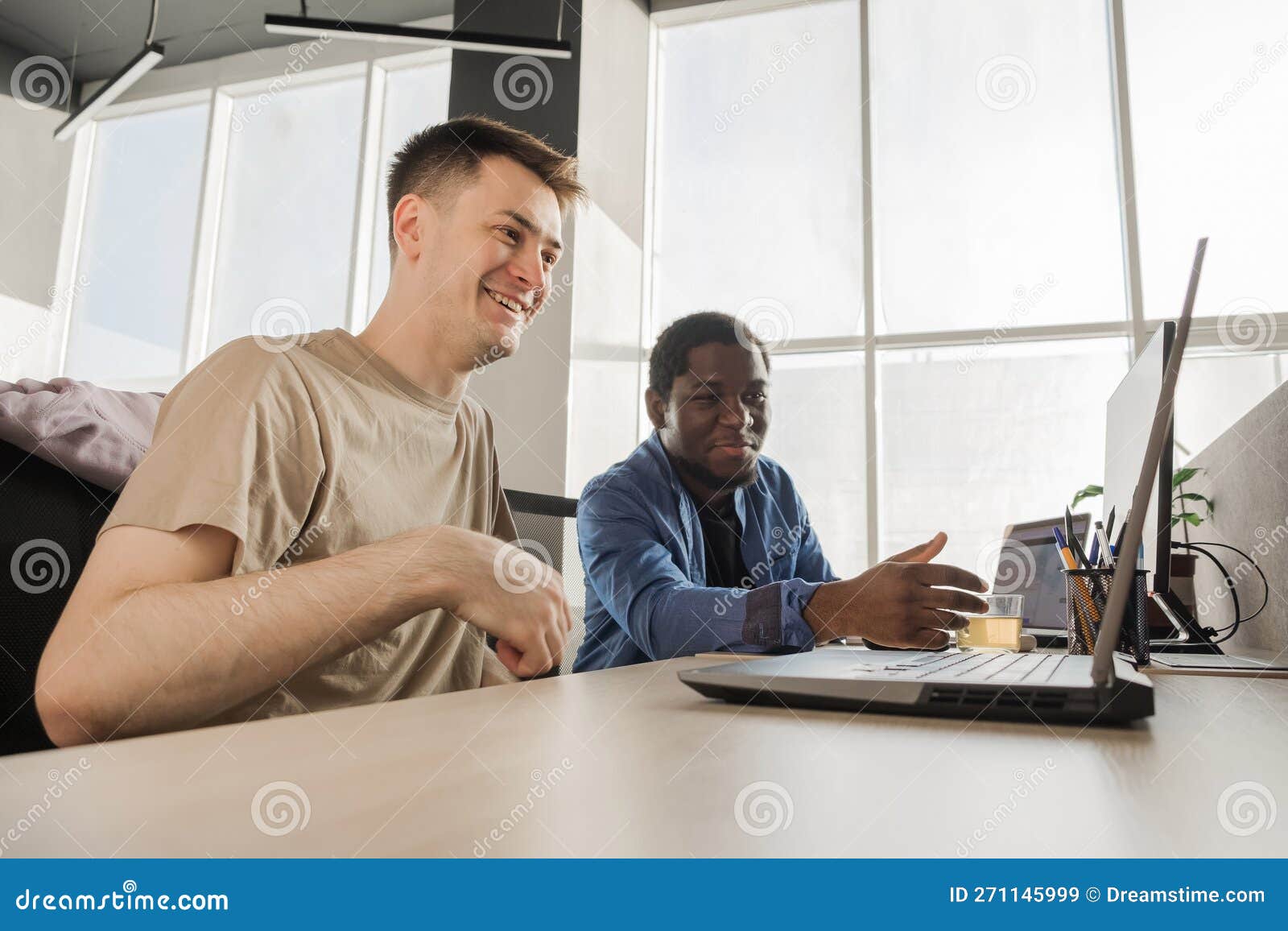 Two Smiling Positive Programmers Working in the Office of a Software Development Company. Coding ...