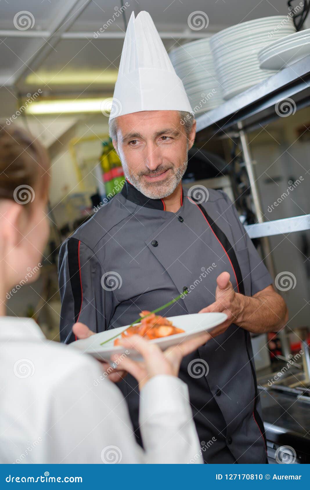 Two Smiling Professional Cooks Working at Restaurant Kitchen Together ...