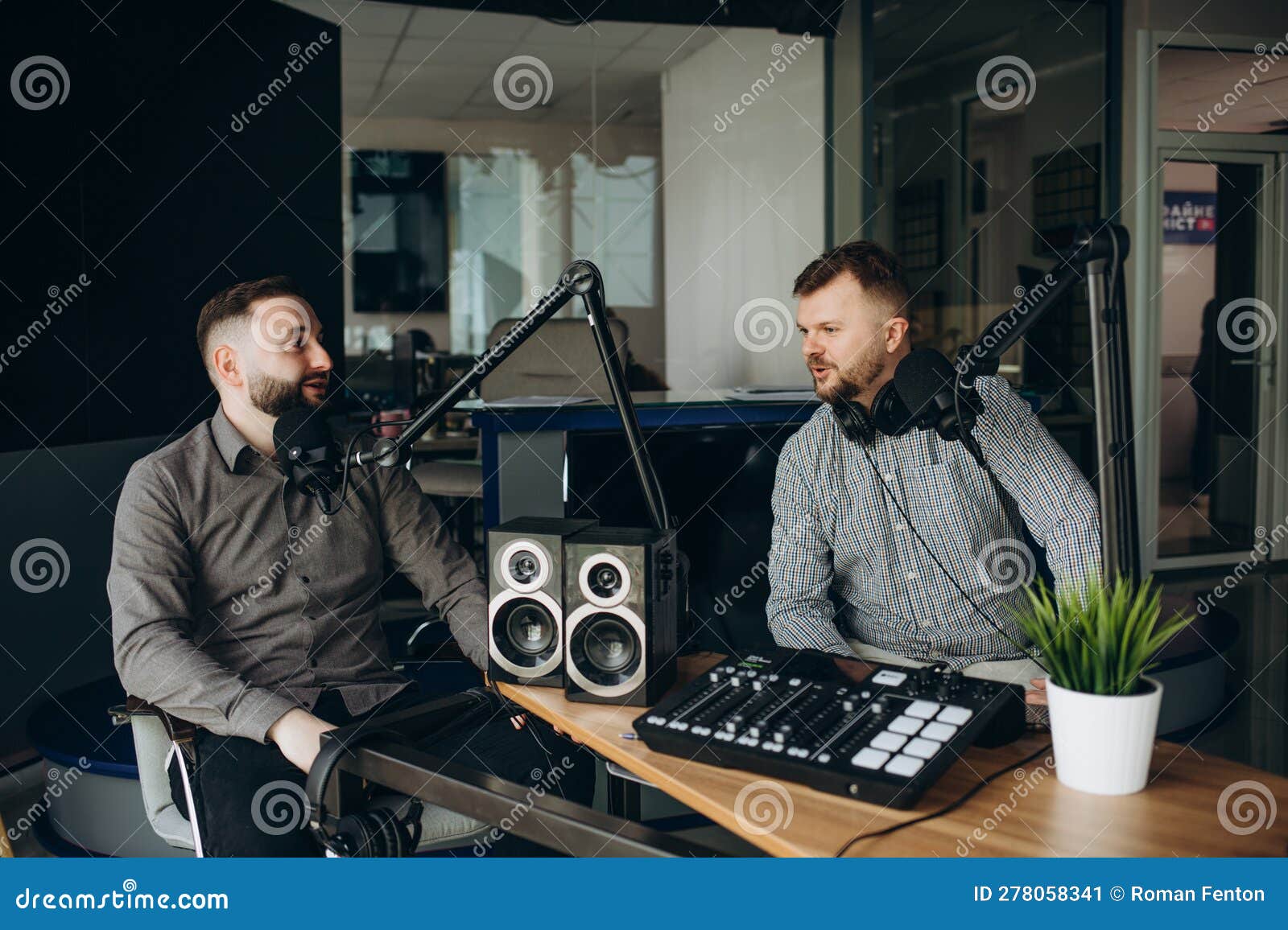 Two Smiling Radio Hosts Talking while Recording Podcast in Broadcasting ...