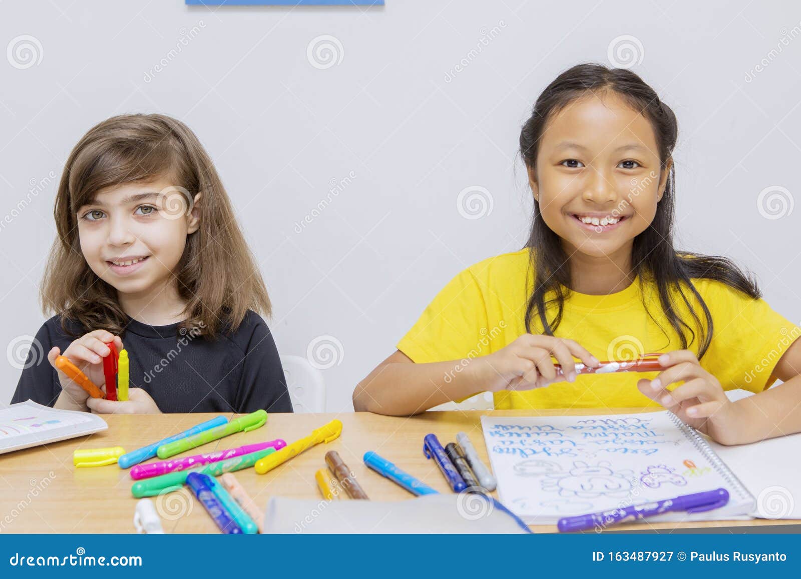 Two Smiling Schoolgirls Studying in the Classroom Stock Image - Image ...