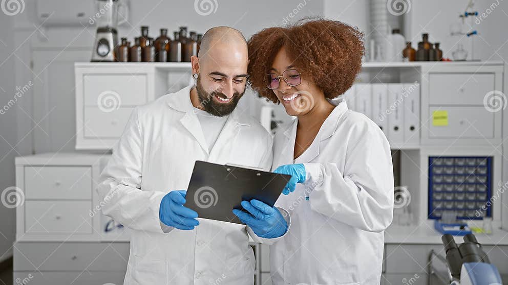 Two Smiling Scientists in the Lab, Engrossed in a Lively Chat while ...