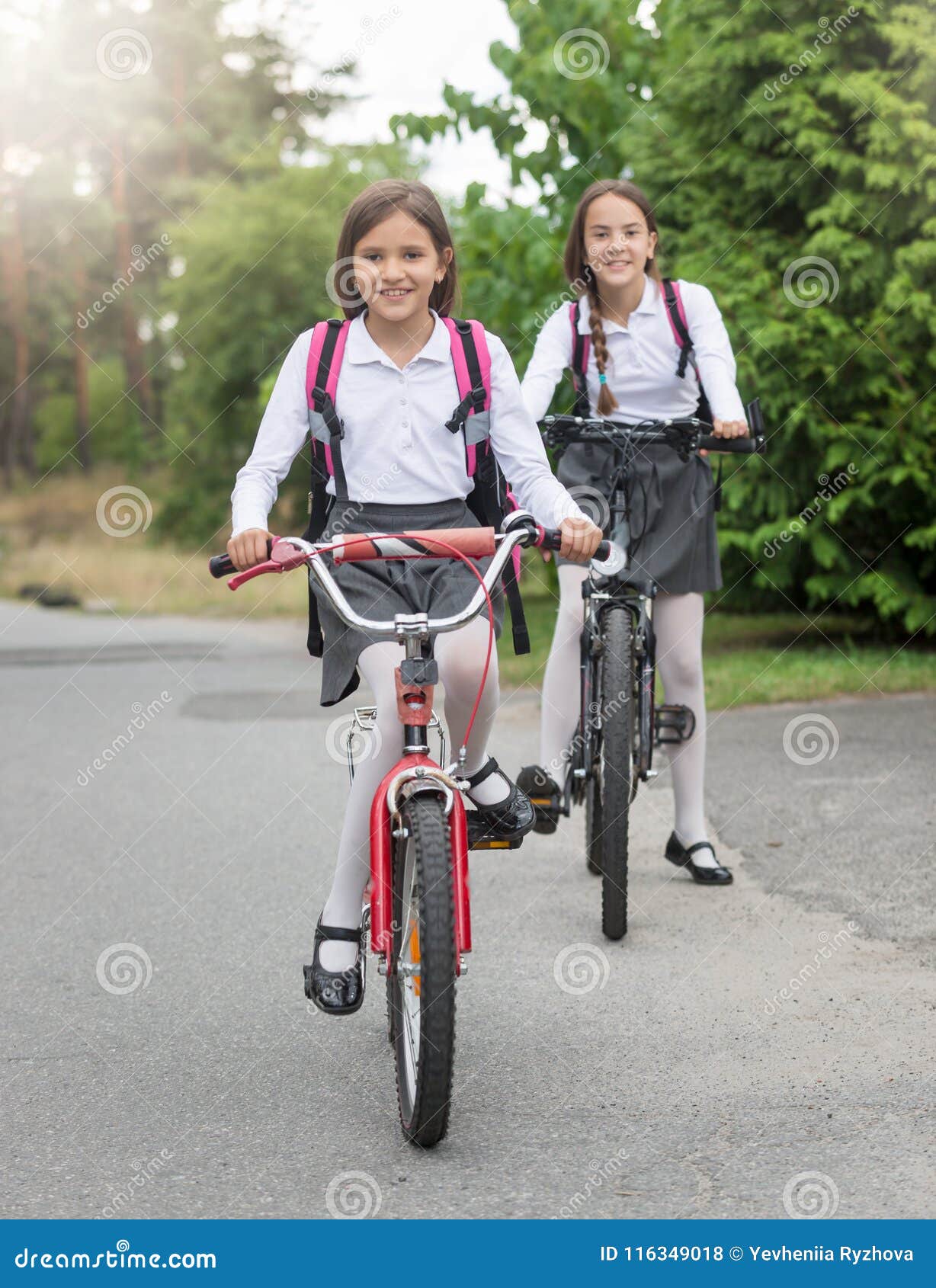 Two Smiling Sisters Riding To School on Bicycles Stock Photo - Image of ... Two Smiling Sisters Riding To School on Bicycles Stock Photo - Image of ...
