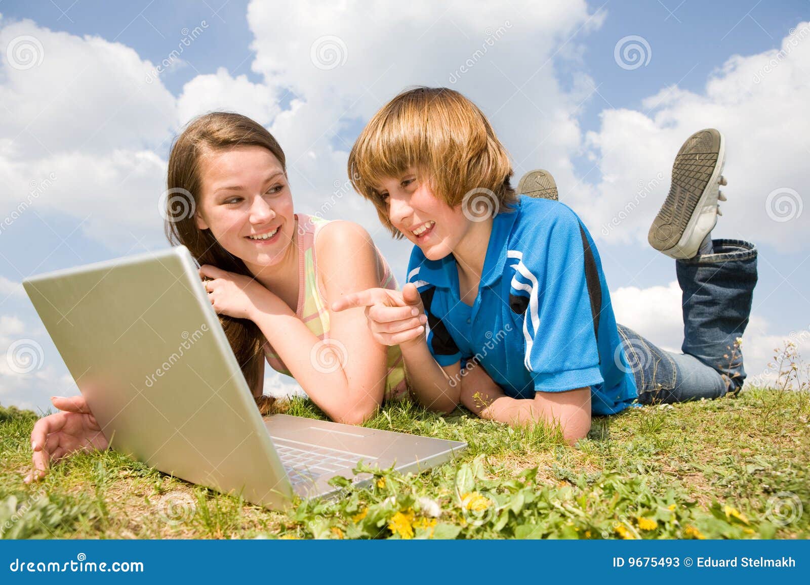 Two Smiling Teenagers with Laptop Stock Image - Image of meadow ...