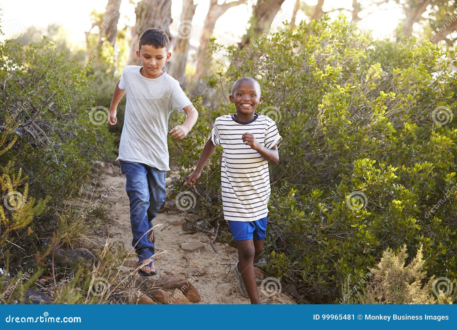 Two Smiling Young Boys Racing on a Forest Path Stock Image - Image of ...