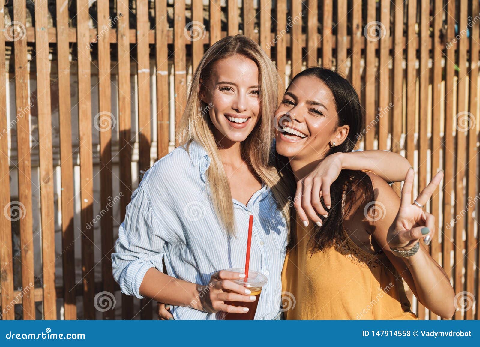 Two Smiling Young Girls Laughing while Standing Outdoors Stock Photo ...