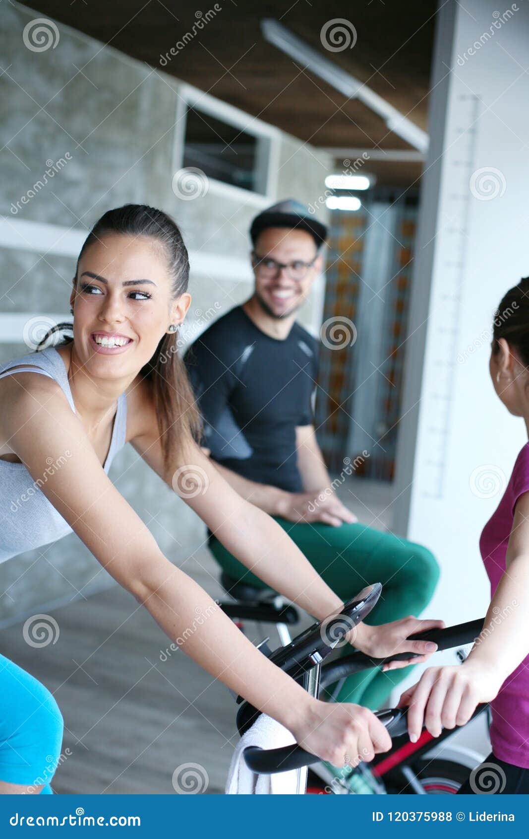 Two Smiling Young People Exercise in Gym. Stock Photo - Image of group ...