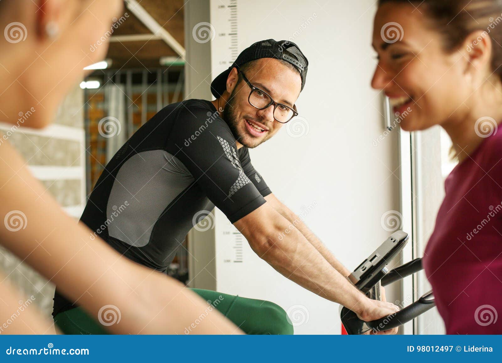 Two Smiling Young People Exercise in Gym. Stock Image - Image of ...