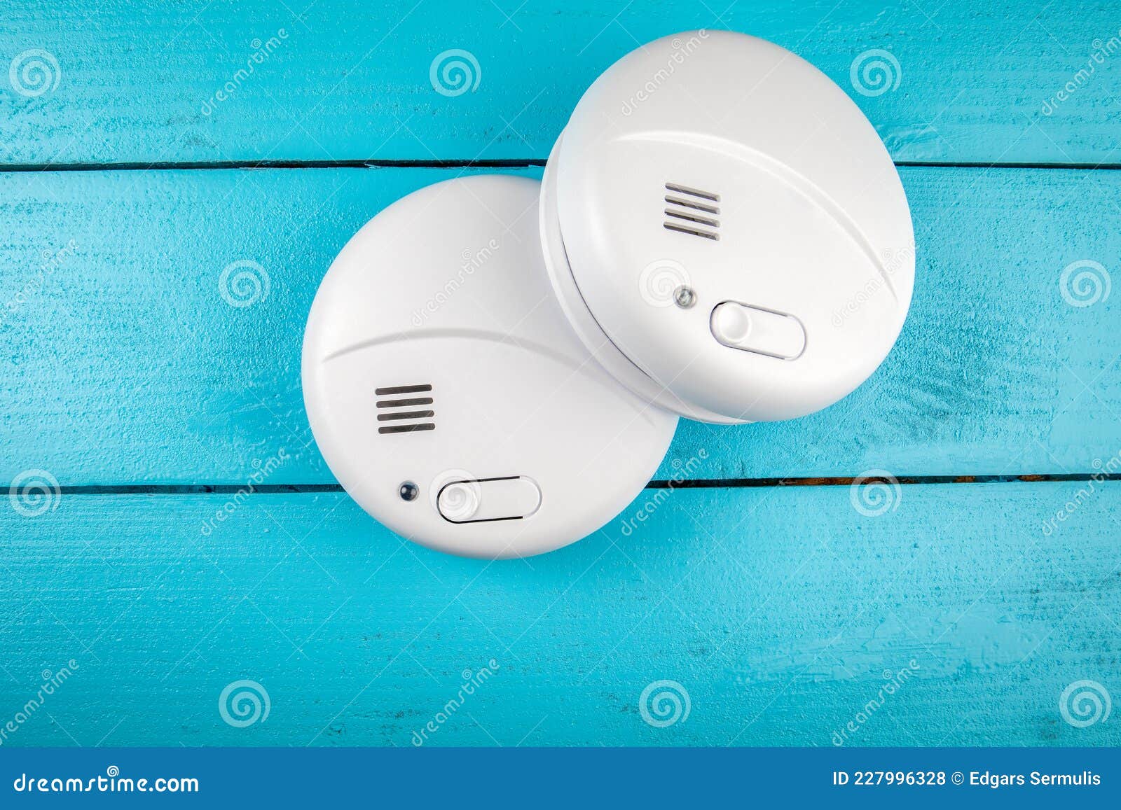 Two Smoke Detectors on a Blue Painted Wooden Surface Stock Photo ...