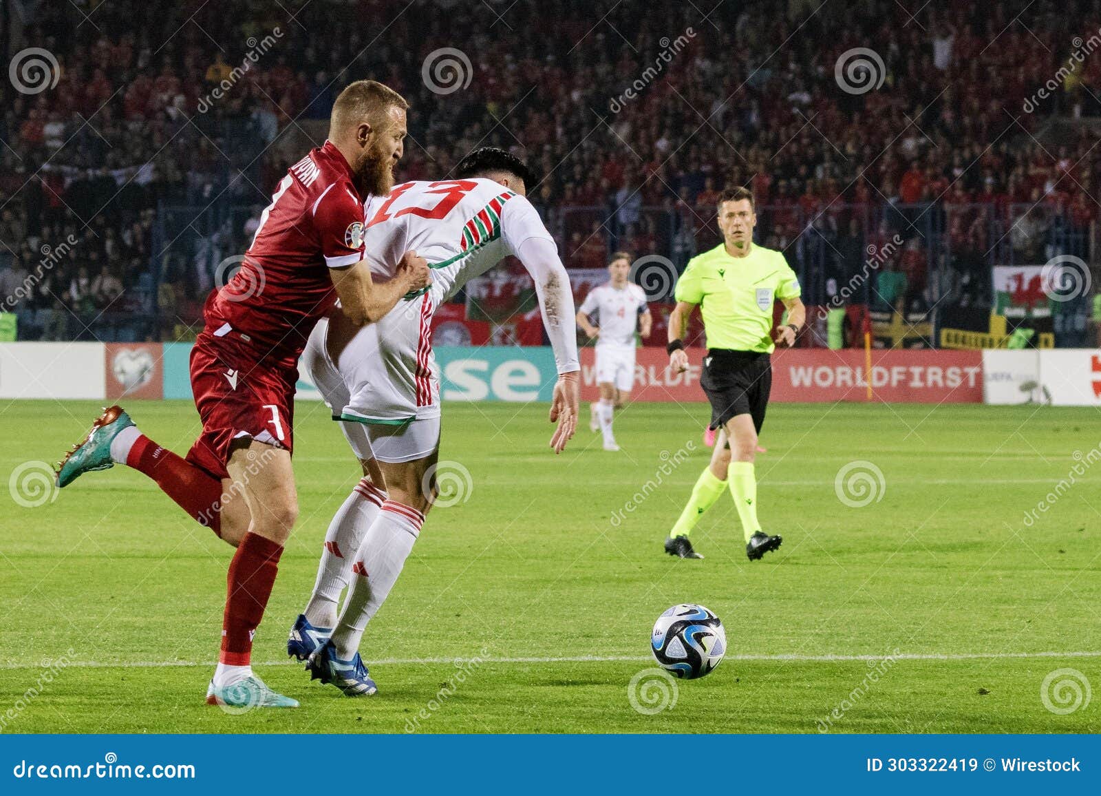 Two Soccer Players Chasing a Ball on the Field during a Match Editorial ...