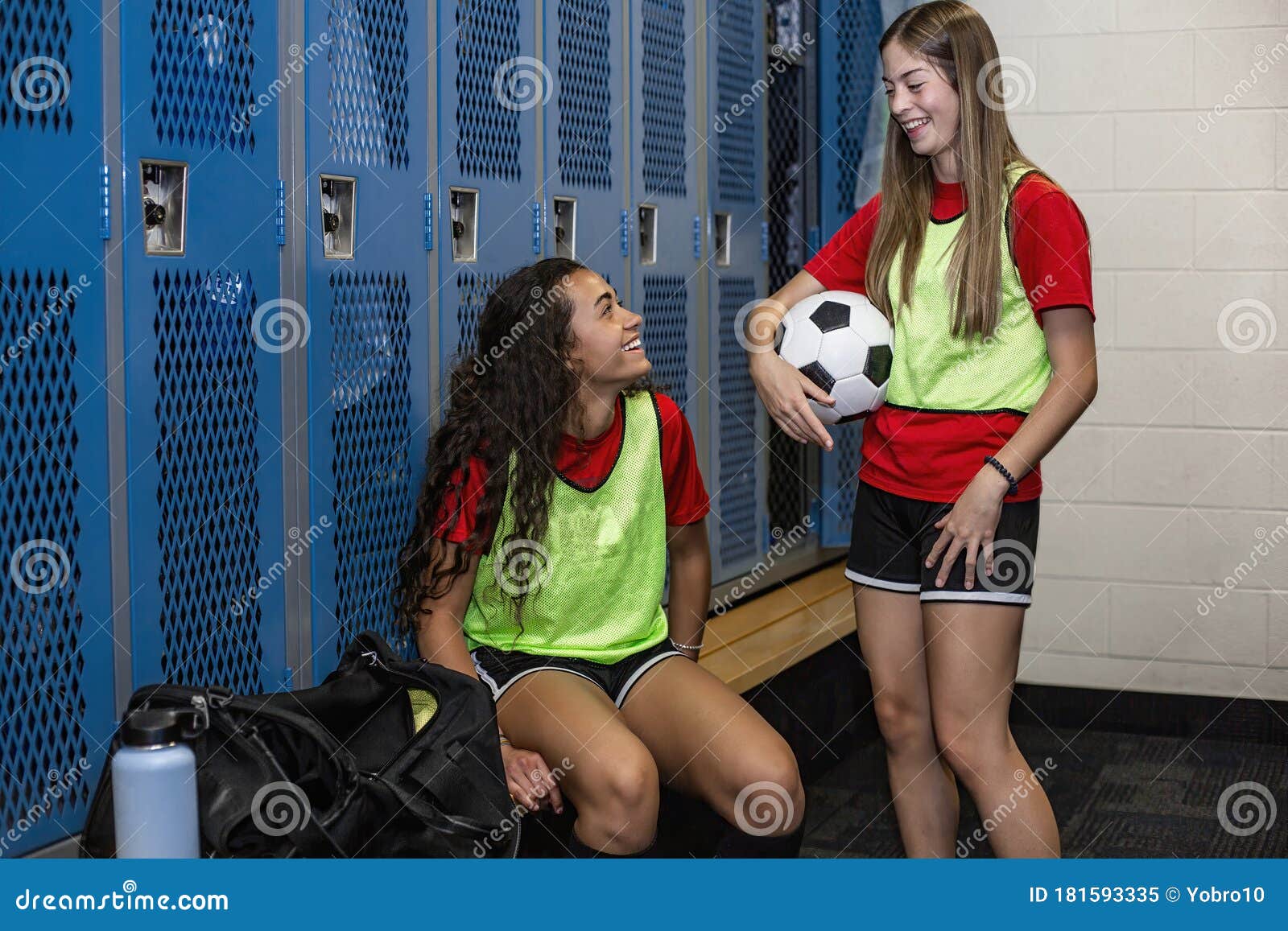 Two Soccer Teammates In A Locker Room Smiling Together After Soccer