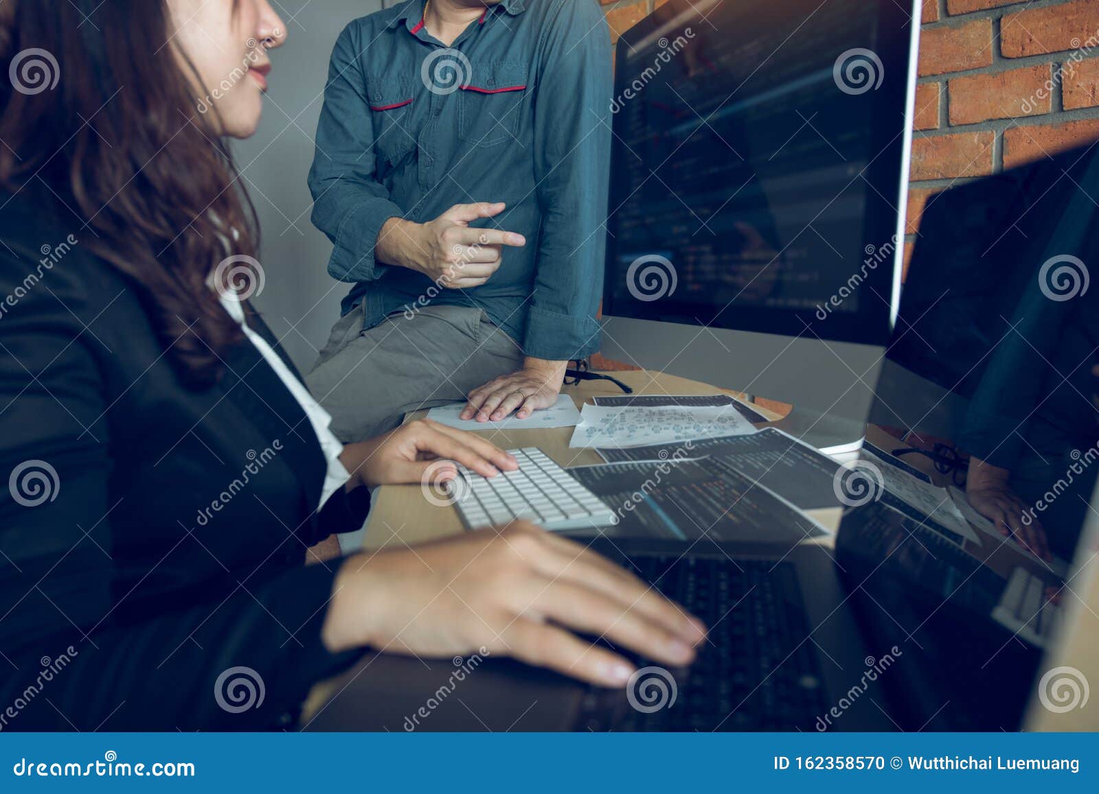 Two Software Developers Are Analyzing Together About The Code Written Into The Program On The