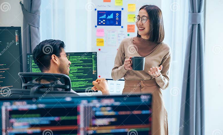 Two Software Developers Engage in a Discussion at Coffee Break Time in a Modern Office, Relax ...