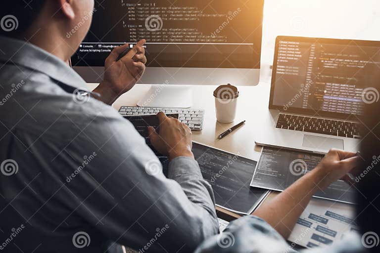 Two Software Developers are Using Computers To Work Together with Their ...
