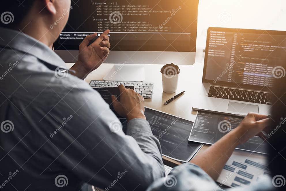 Two Software Developers are Using Computers To Work Together with Their ...