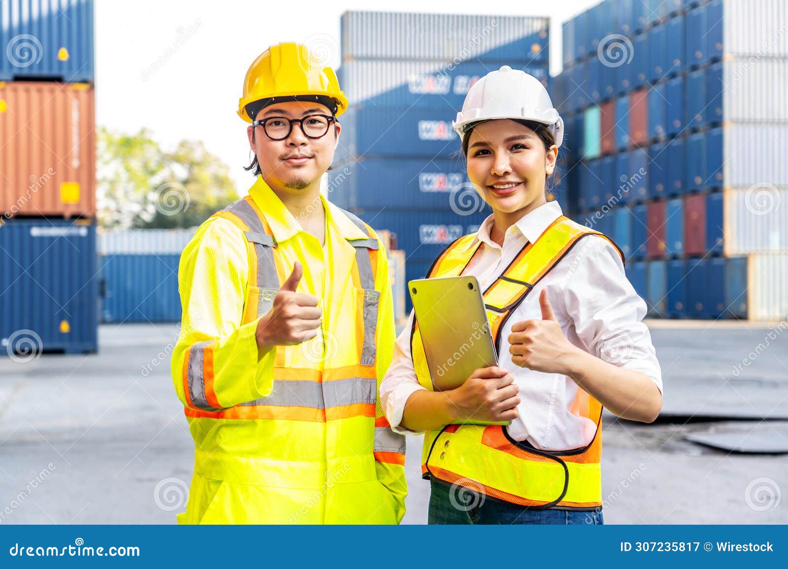 Two Southeast Asian Engineers Posing Confidently in Front of Shipping ...
