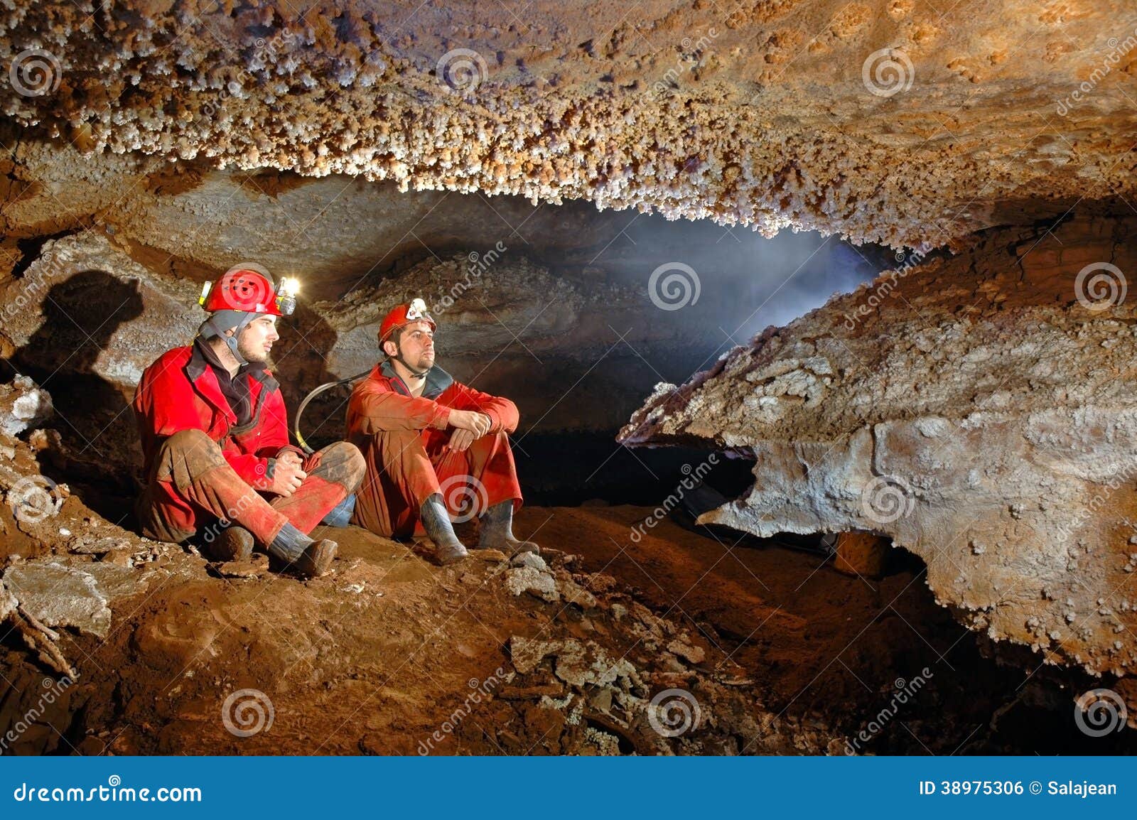 Two spelunkers in a cave stock photo. Image of alone - 38975306