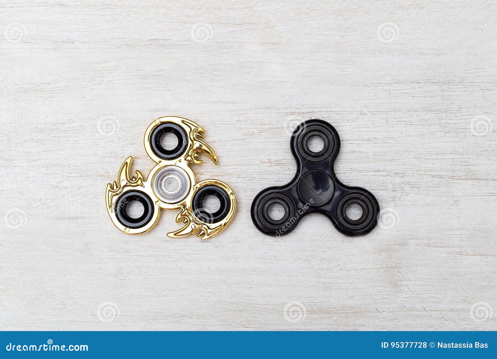 Two Spinners Lie on a White Wooden Background Stock Photo - Image of ...