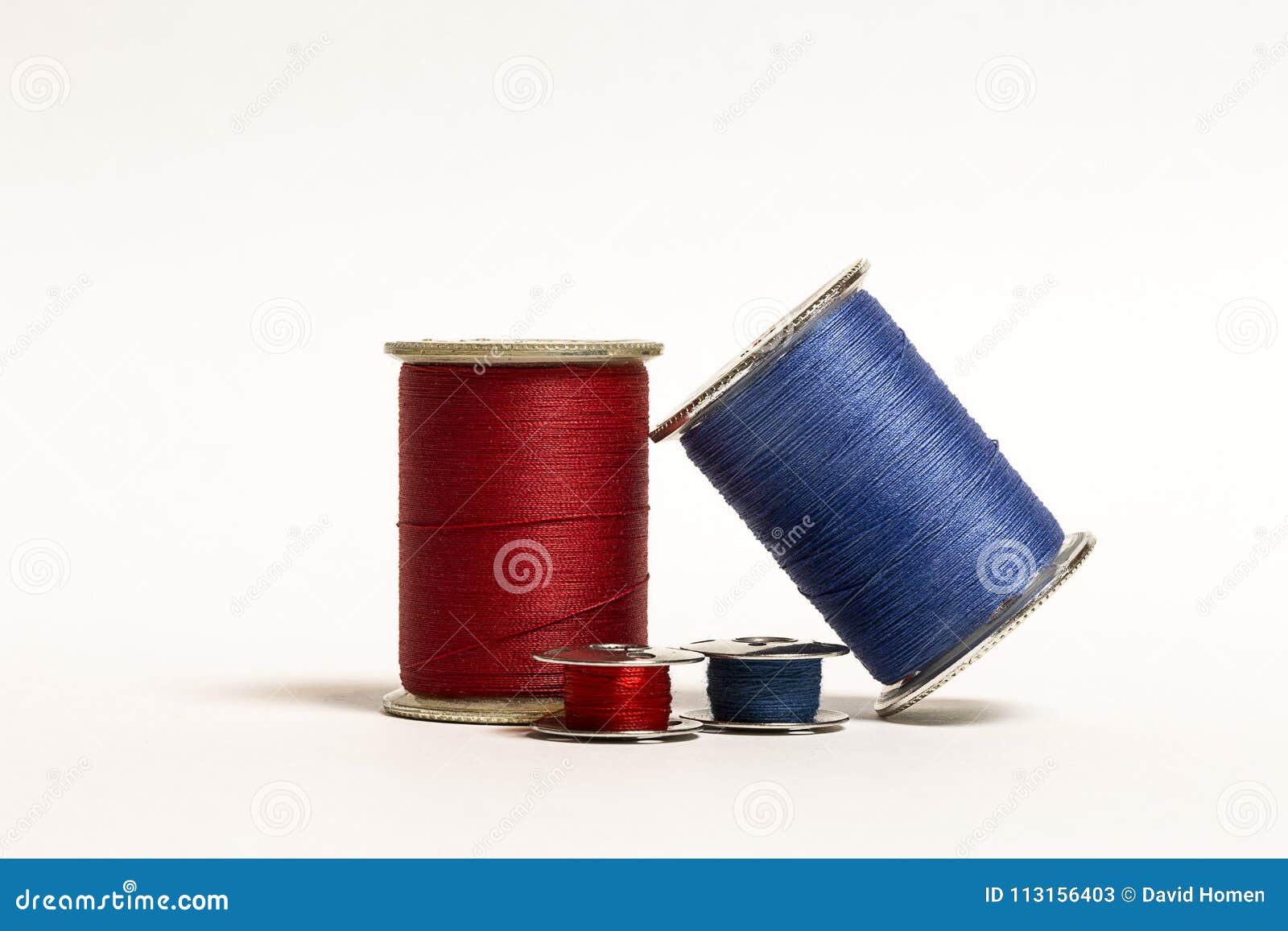Two Spools of Blue and Red Thread with Bobbins Stock Image - Image of ...