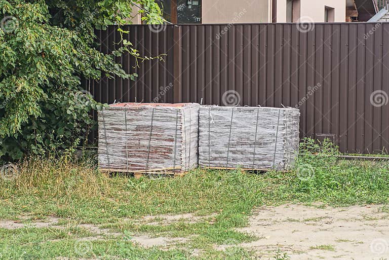 Two Square Boxes in Plastic Packaging with Paving Bricks Stock Image ...