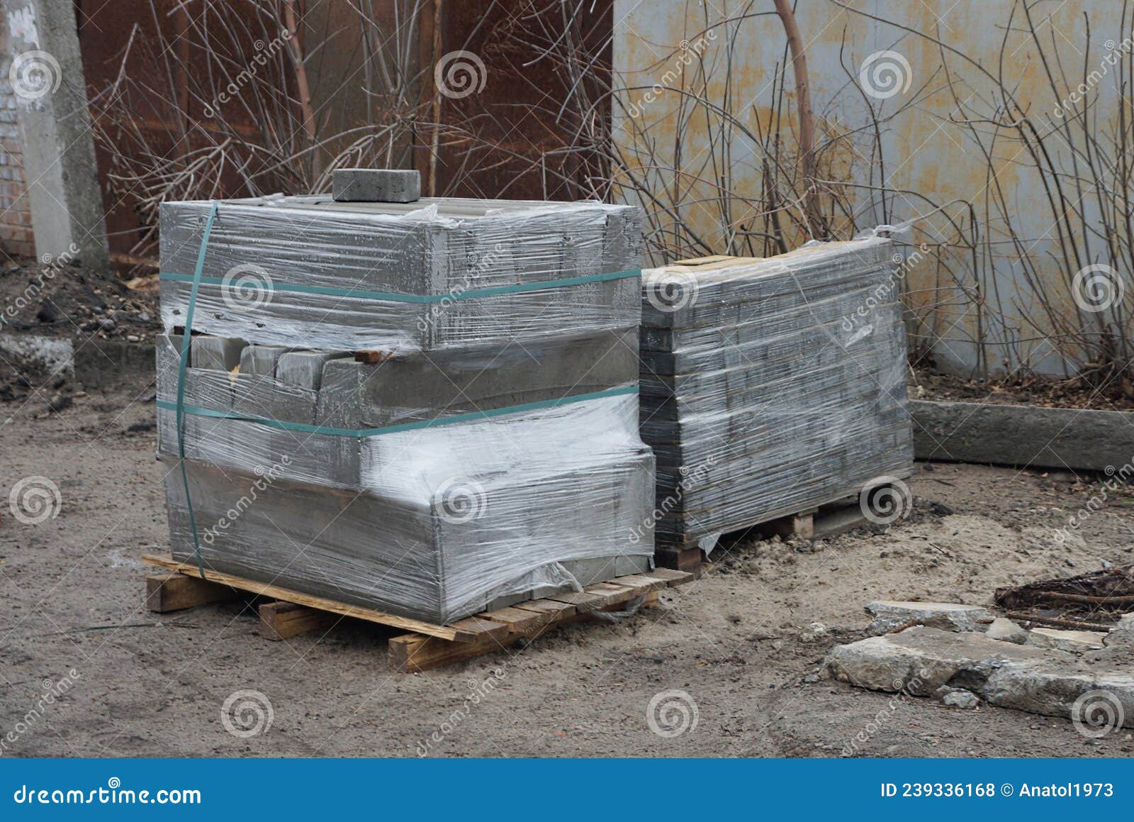 Two Square Boxes in Plastic Packaging with Paving Bricks Stock Photo ...