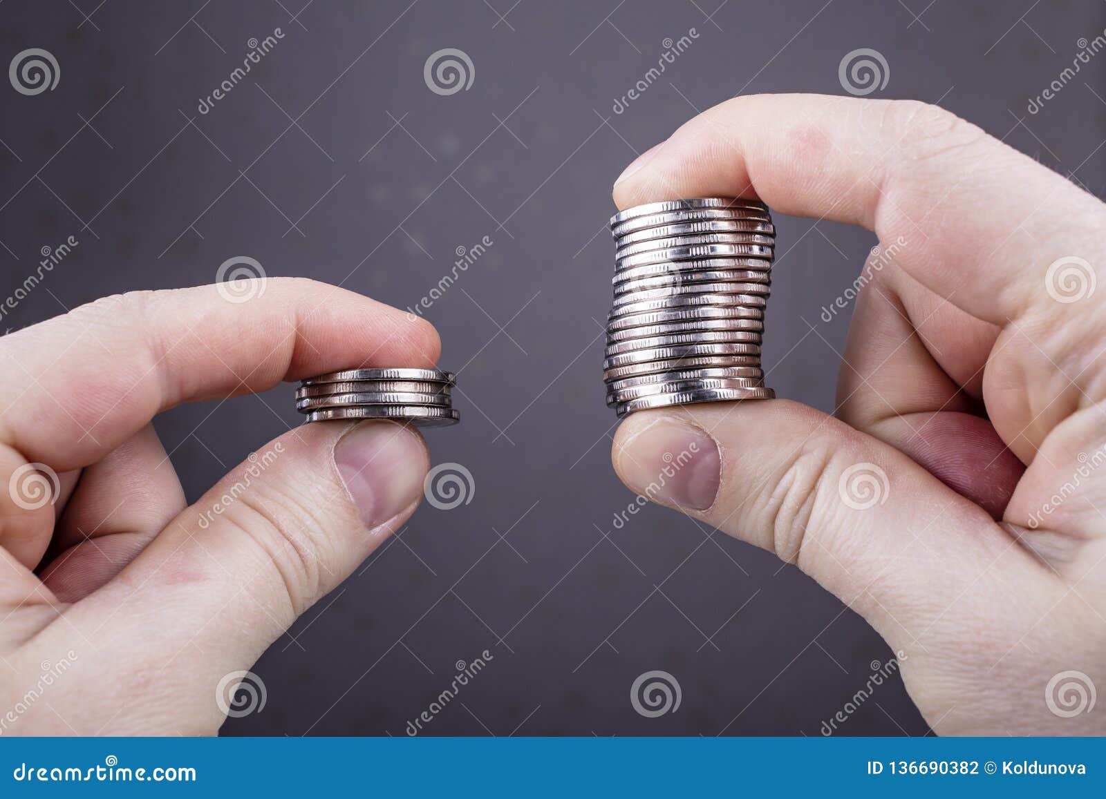 Two Stacks of Coins of Different Sizes in the Hands Stock Photo - Image ...