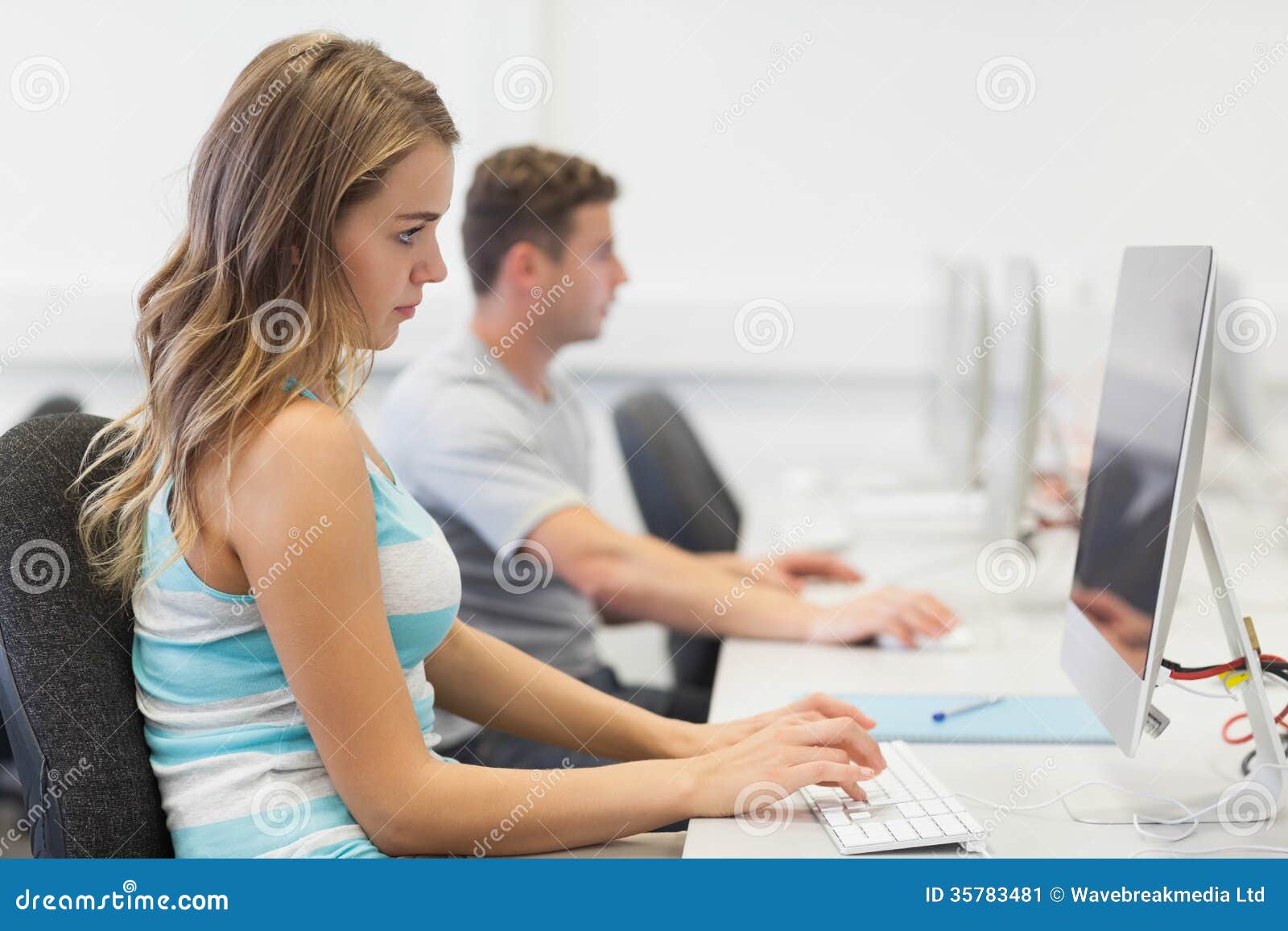 Two Stern Students Working on Computer Individually Stock Image - Image ...