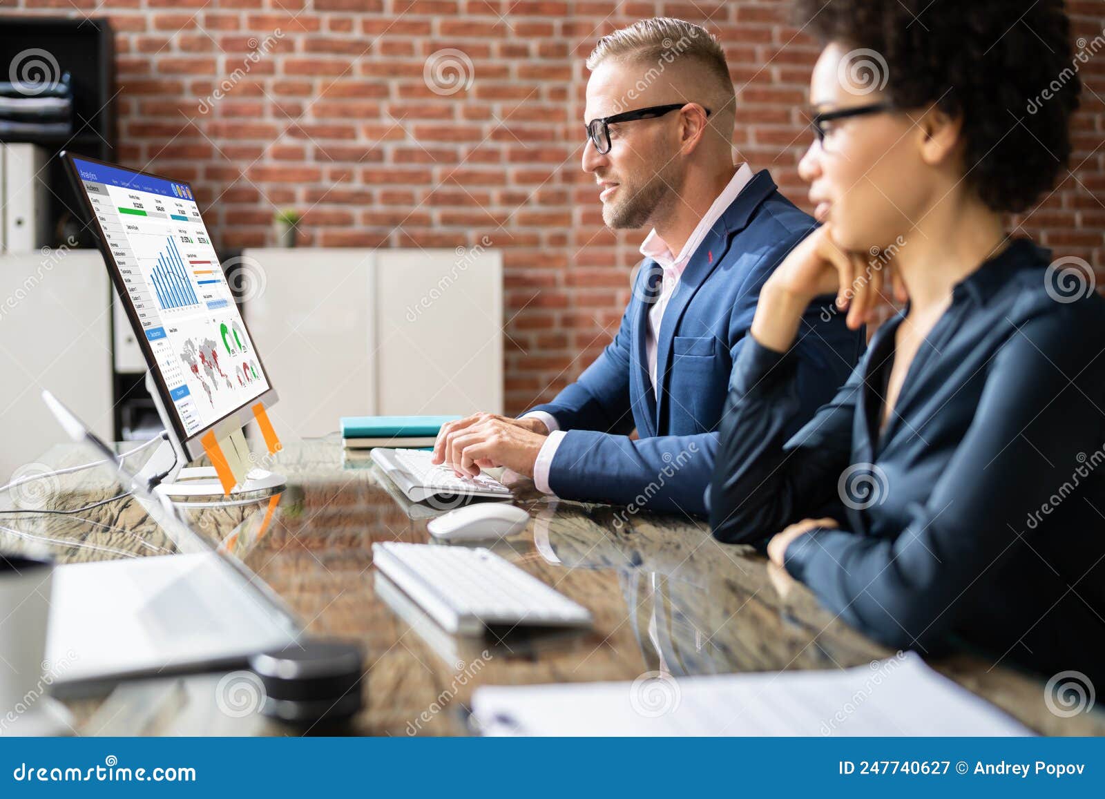 Two Stock Market Brokers Discussing Graphs on Computer Stock Image ...