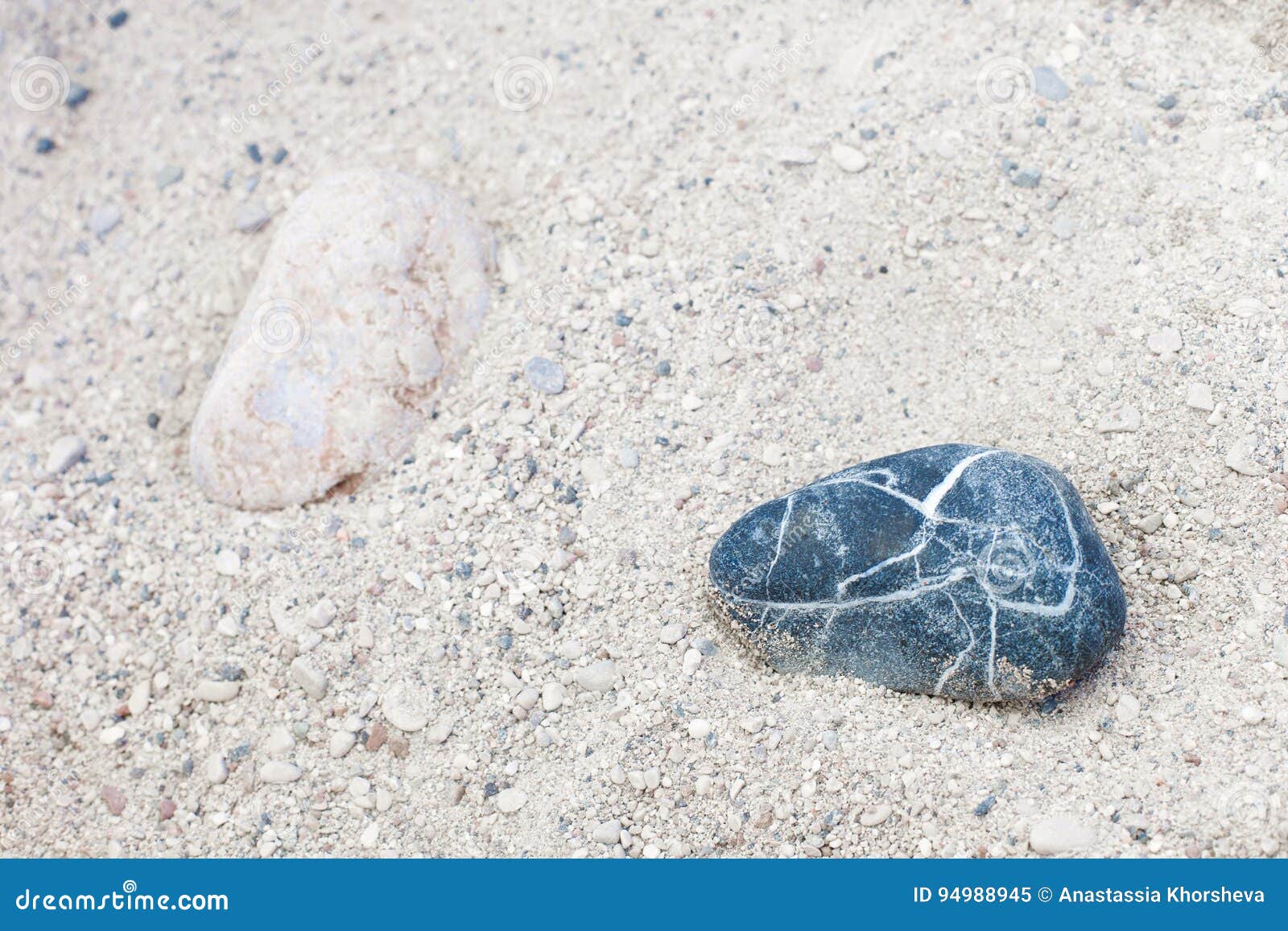 Two Stones, Light and Dark, Laying Separately on the Sand Stock Image ...
