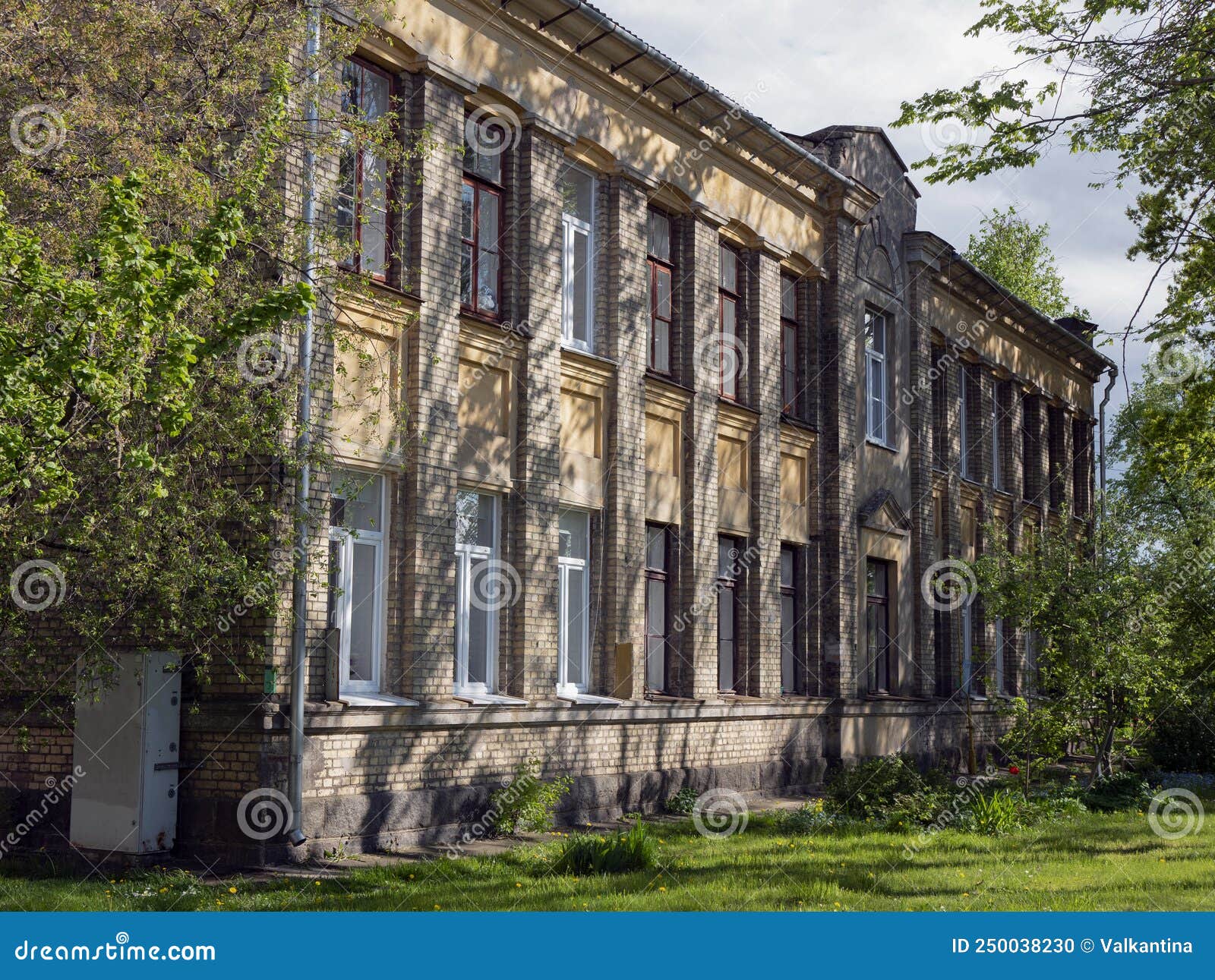 Two-story Old Brick Building with a Triangular Pediment Under Bright ...