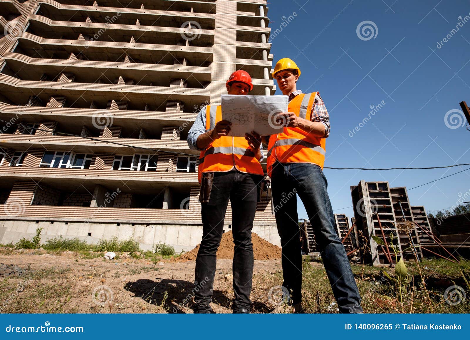 Two Structural Engineers Dressed in Shirts, Orange Work Vests and ...
