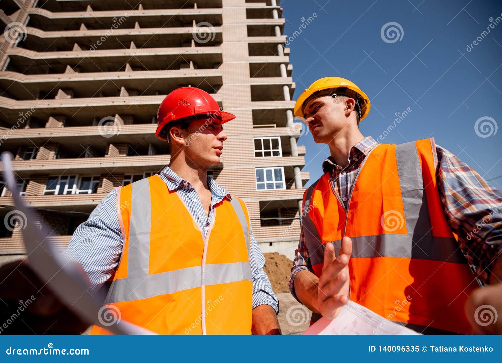 Two Structural Engineers Dressed in Shirts, Orange Work Vests and ...