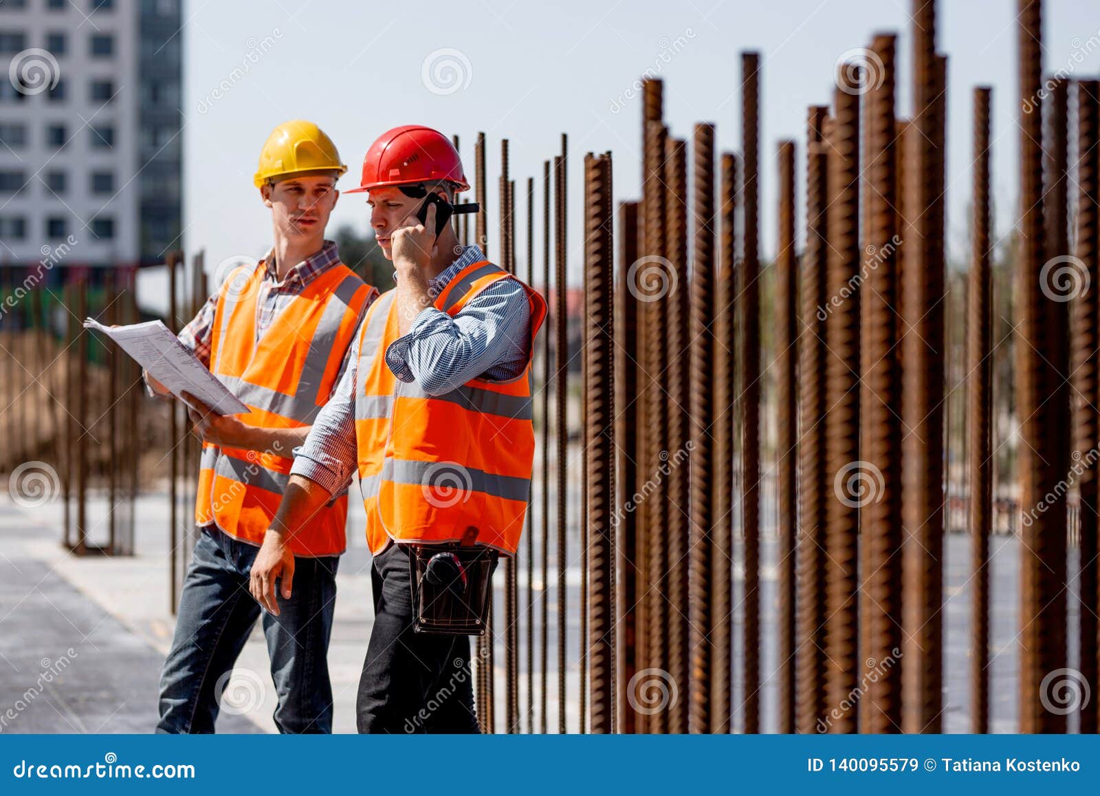 Two Structural Engineers Dressed in Shirts, Orange Work Vests and ...
