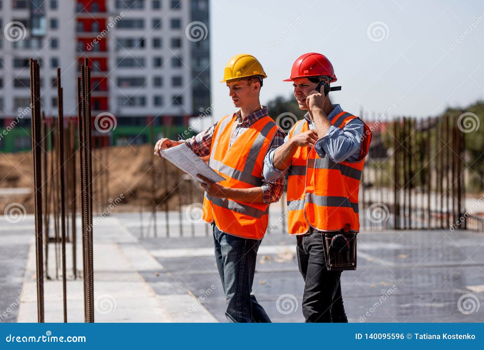 Two Structural Engineers Dressed in Shirts, Orange Work Vests and ...