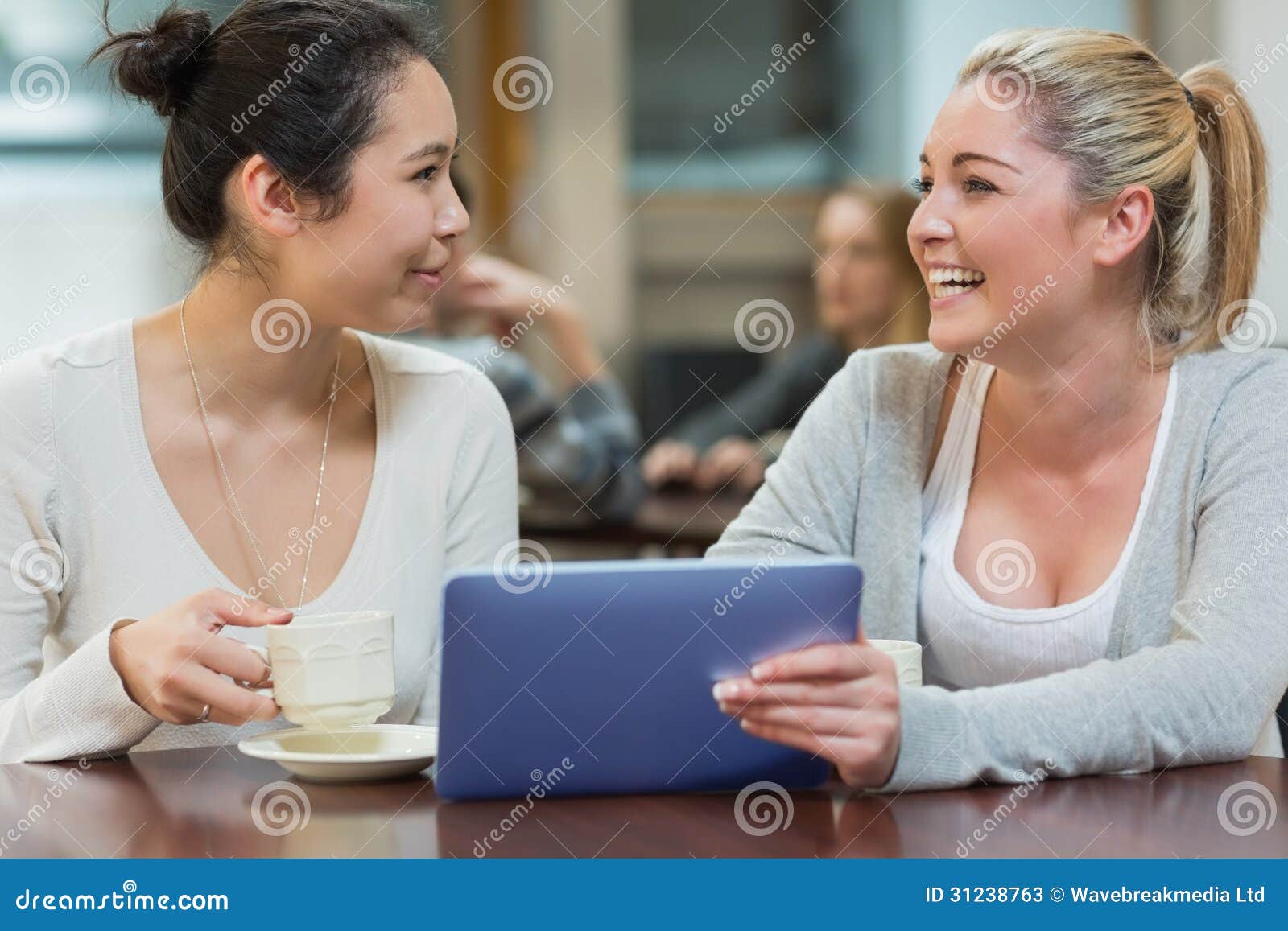 Two Students Chatting in a Coffee Shop Stock Image - Image of computer ...