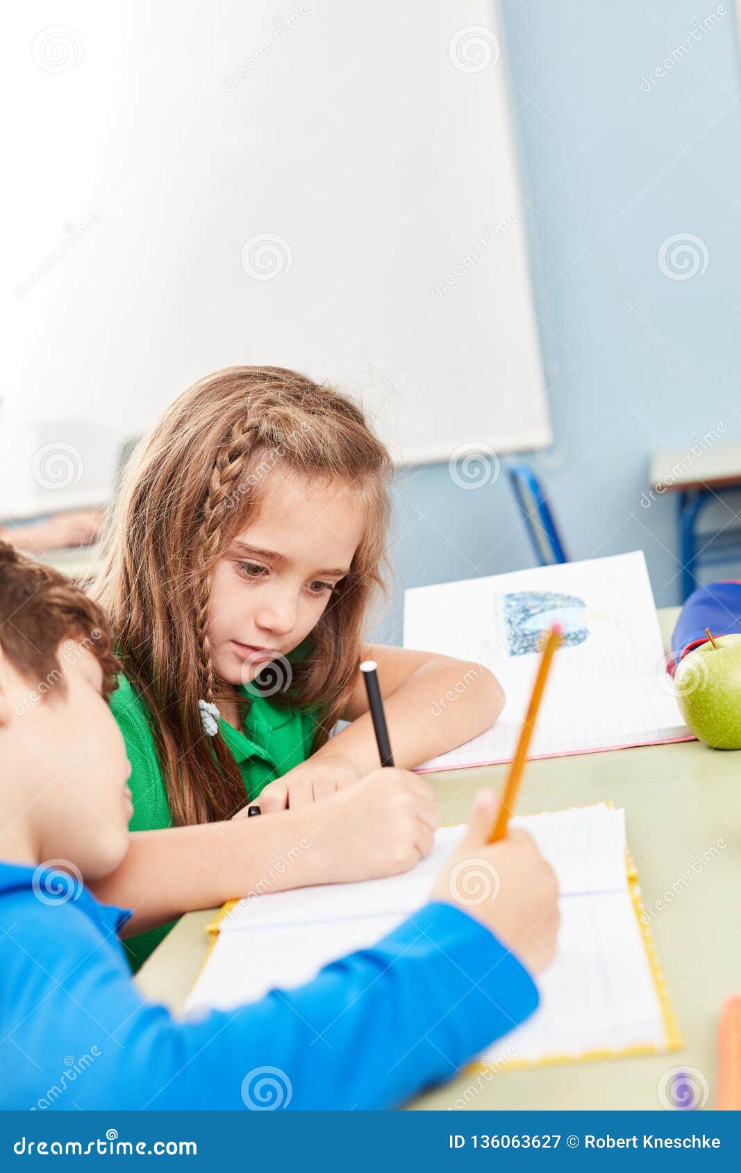 Two students write a test stock image. Image of young - 136063627
