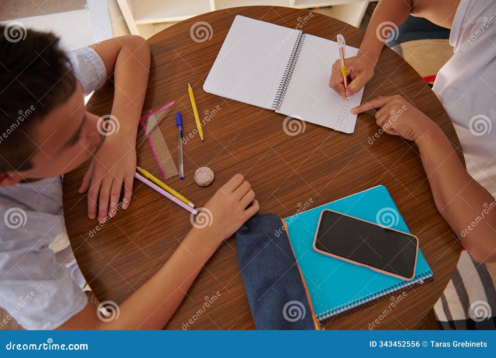Two Students Collaborating on a Homework Project at a Round Table Stock ...