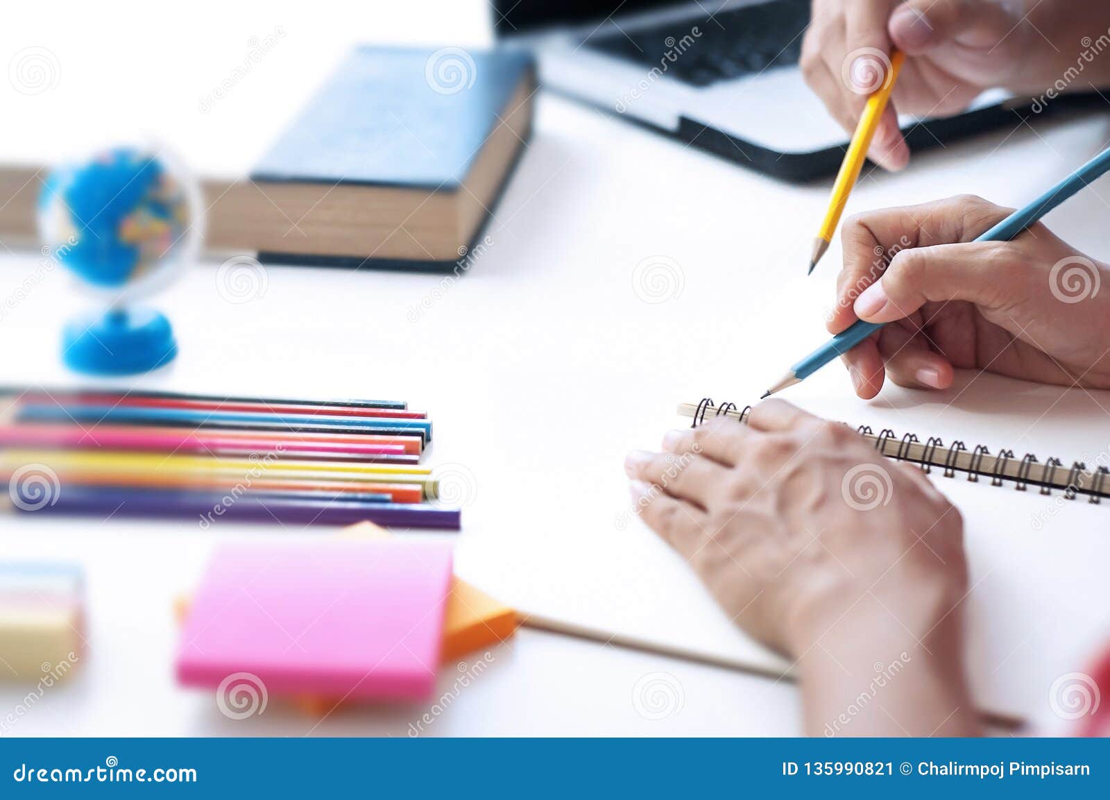 Two Students Doing Homework and Helping Each Other Sitting in a Table ...