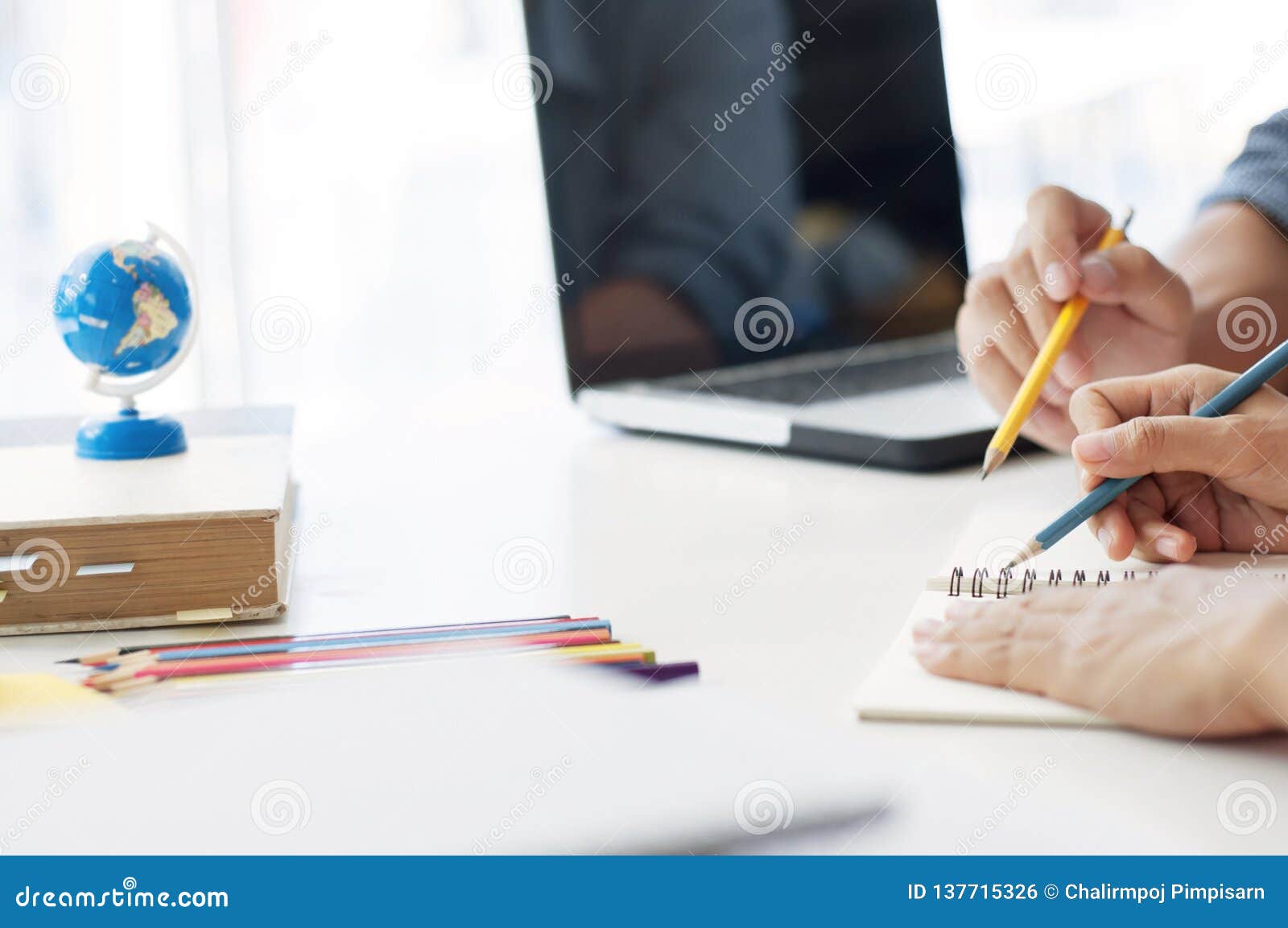 Two Students Doing Homework Together and Helping Each Other Sitting in ...