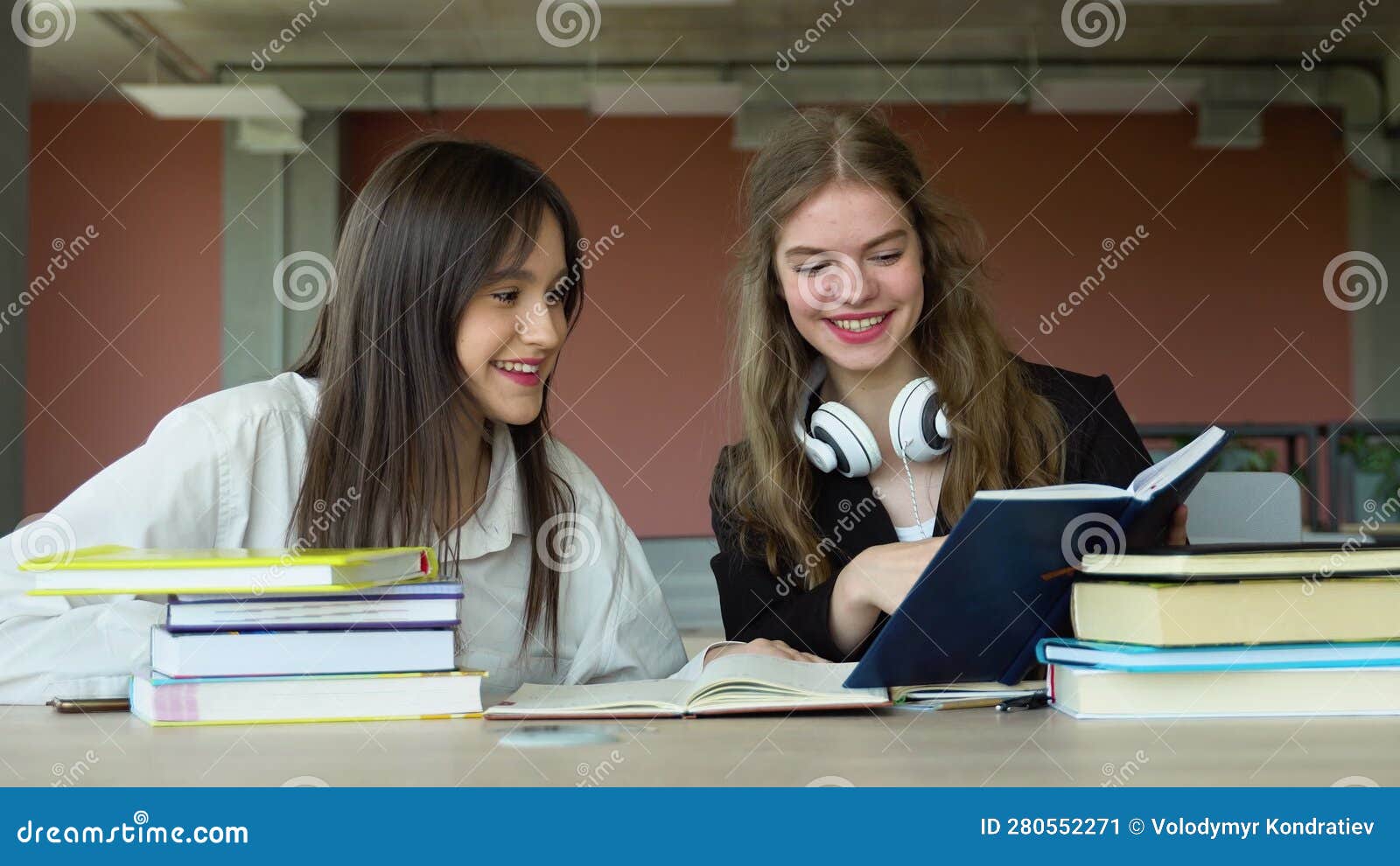 Two Students Doing Homework Together and Helping Each Other Sitting in ...