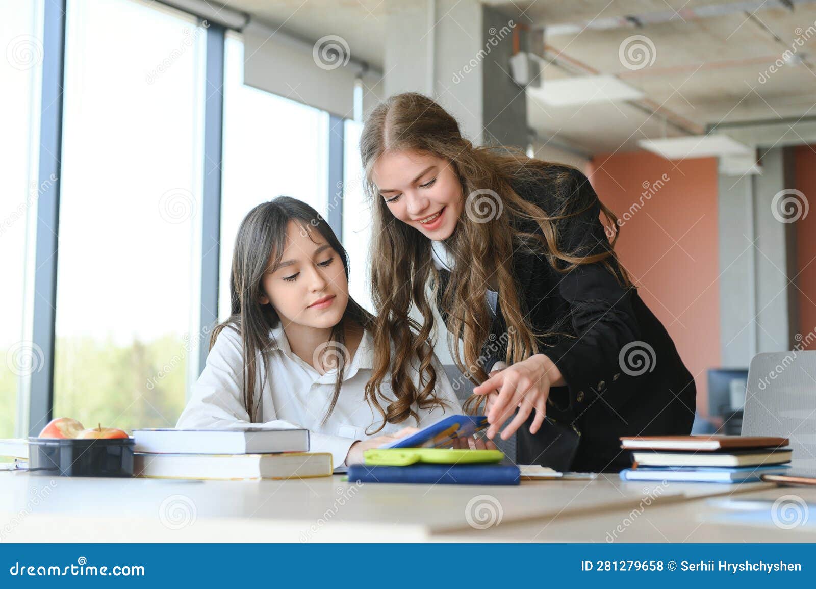 Two Students Doing Homework Together and Helping Each Other Sitting in ...
