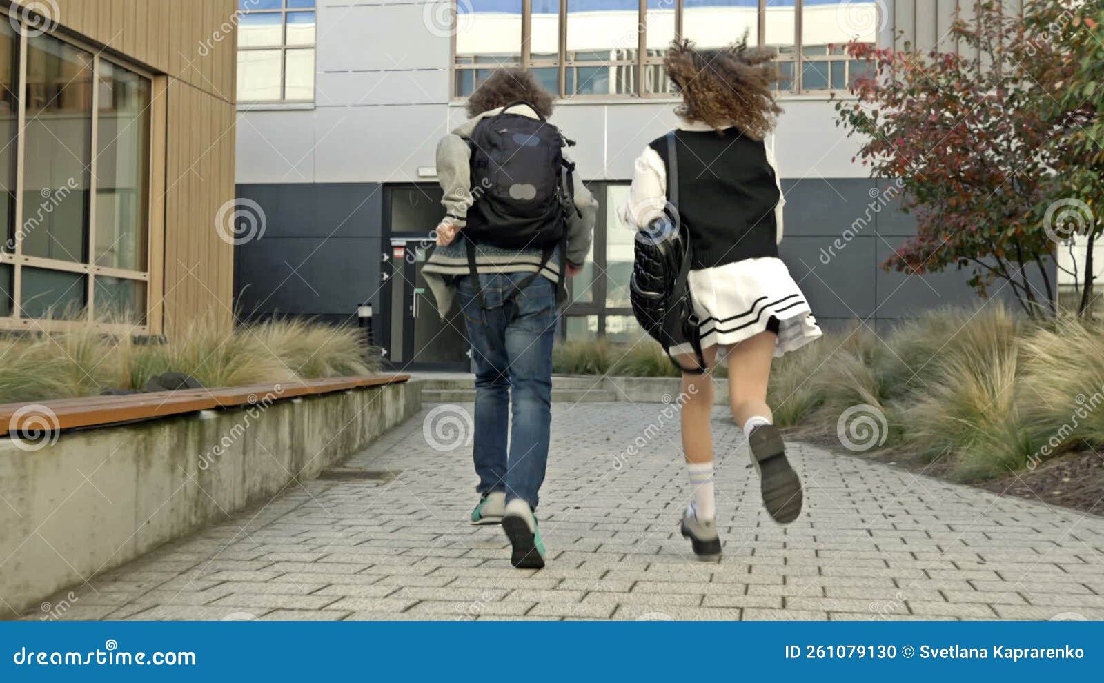 Two Students, a Girl and a Guy, are Running Around the Courtyard of the ...