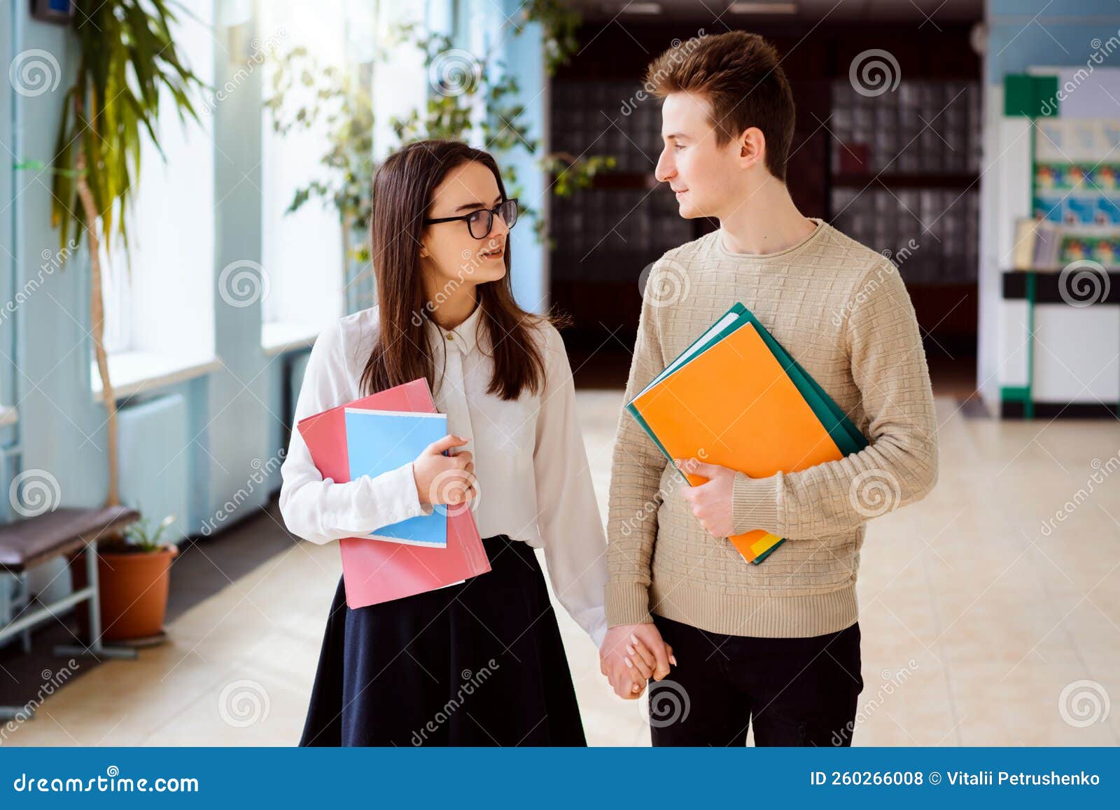 Two Students Going in the Corridor of University Building after Classes ...
