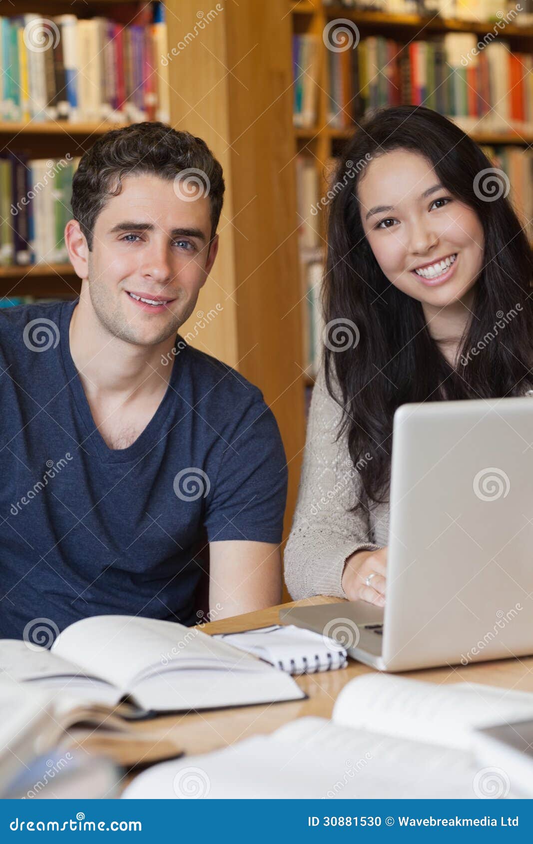 Two Students Learning with a Laptop in a Library Stock Photo - Image of ...