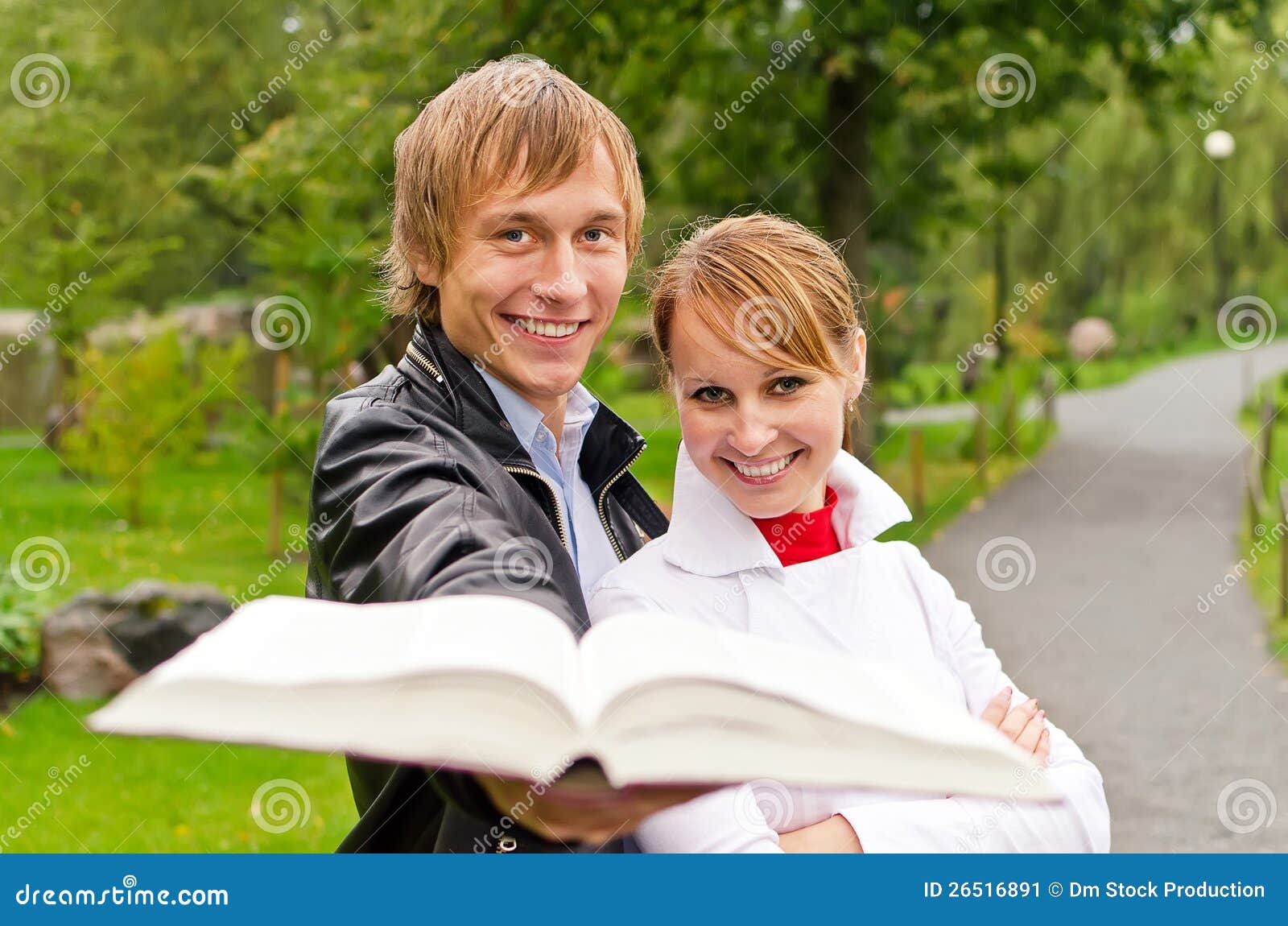 Two Students with Open Book Stock Image - Image of campus, education ...