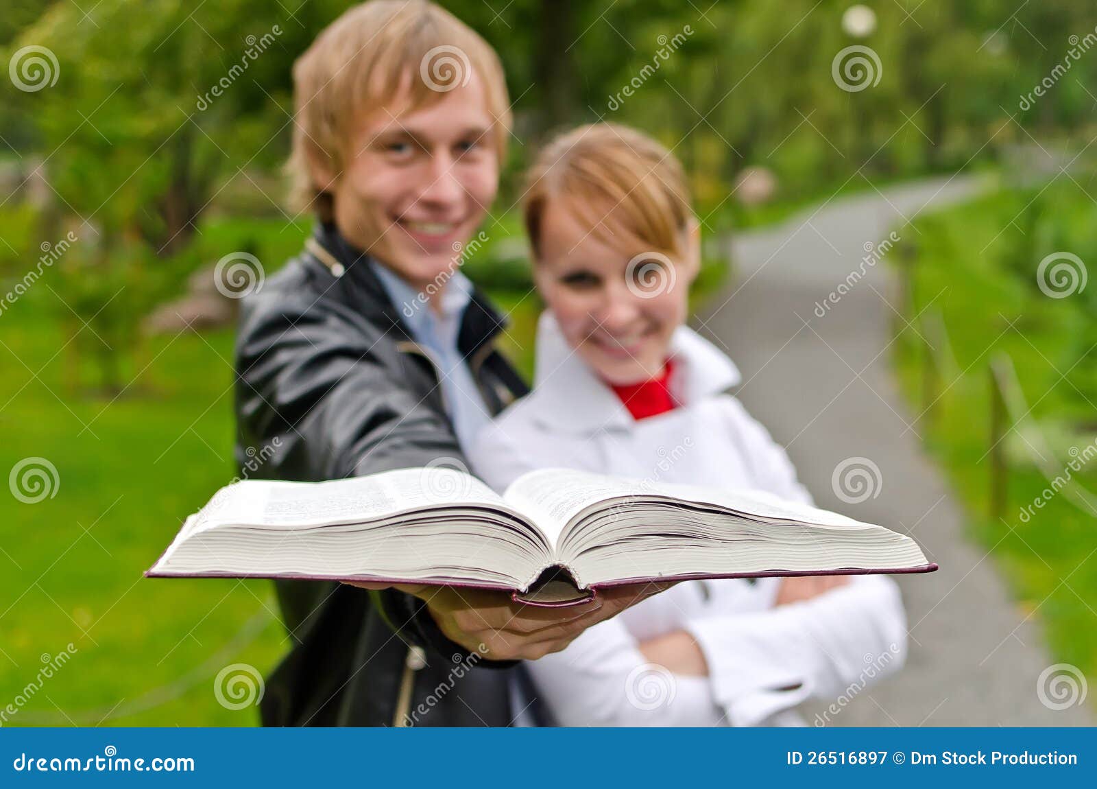 Two Students with Open Book Stock Image - Image of casual, giving: 26516897
