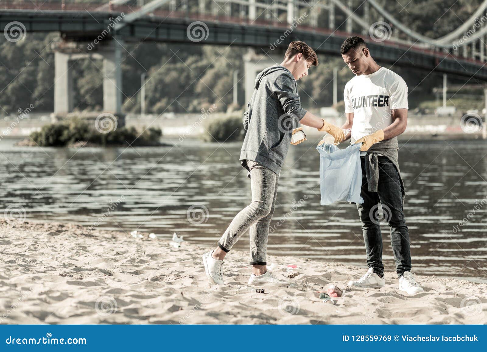 Two Students Participating in Voluntary Work Helping Each Other ...